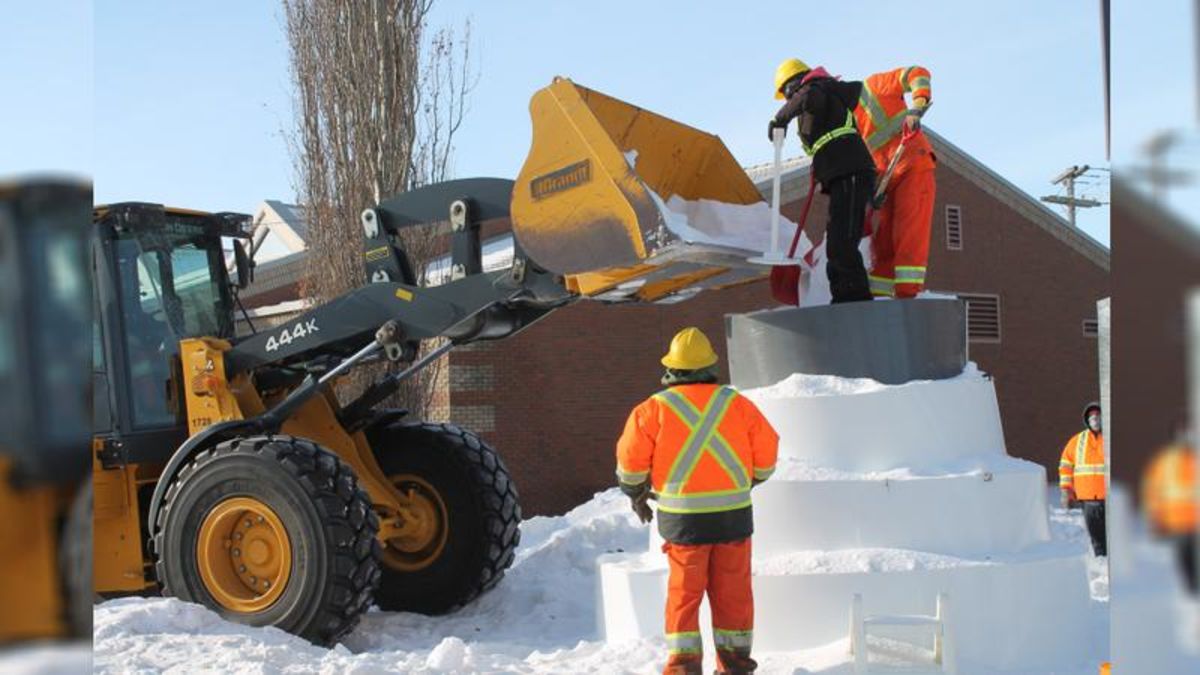 Artist creating snow sculpture as part of Wintertainment activities ...