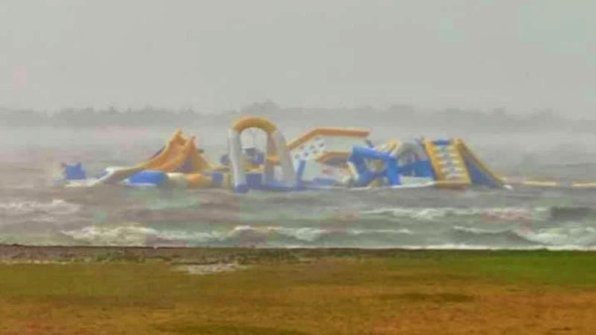 Kids narrowly escape after inflatable playground toppled in storm ...
