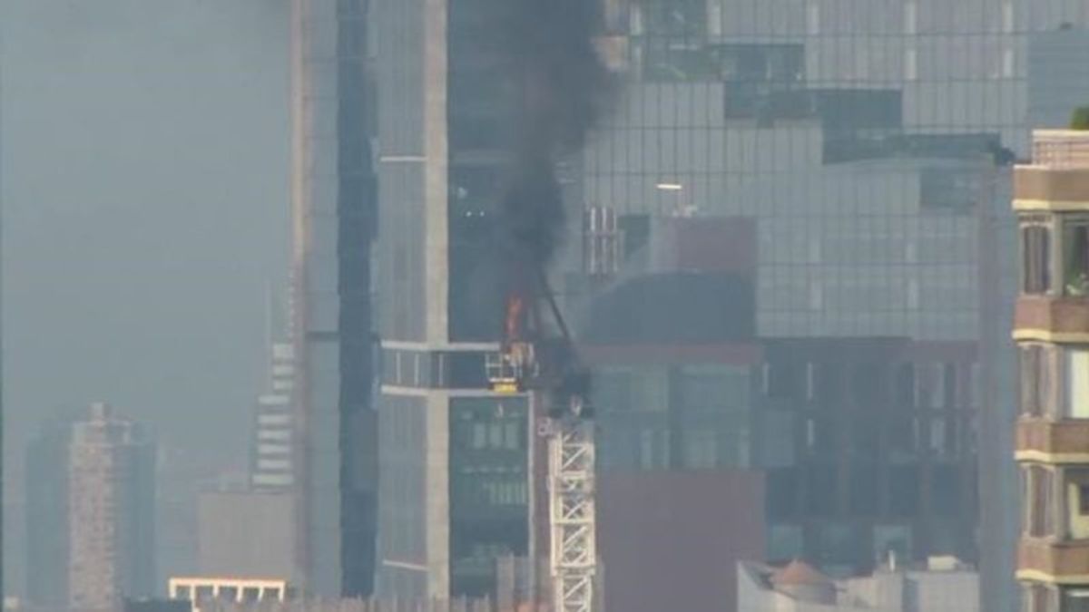 Construction crane catches fire in New York City and hits building as ...