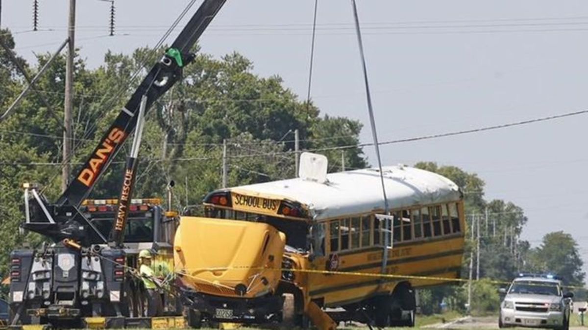 An Ohio school bus overturns after crash with minivan, leaving 1 child ...